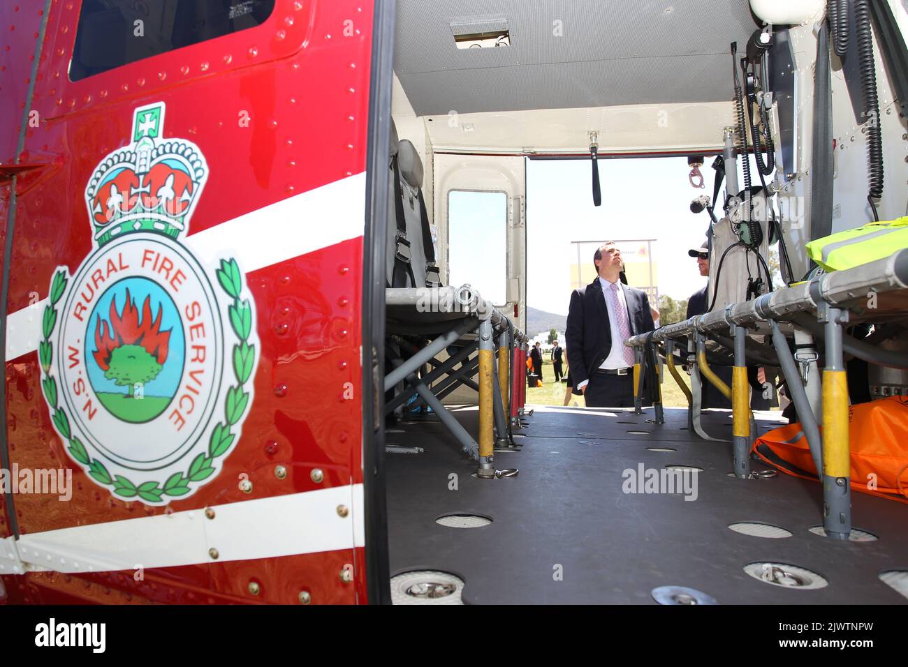 Minister Michael Keenan is shown around the Bell 412 firefighting ...