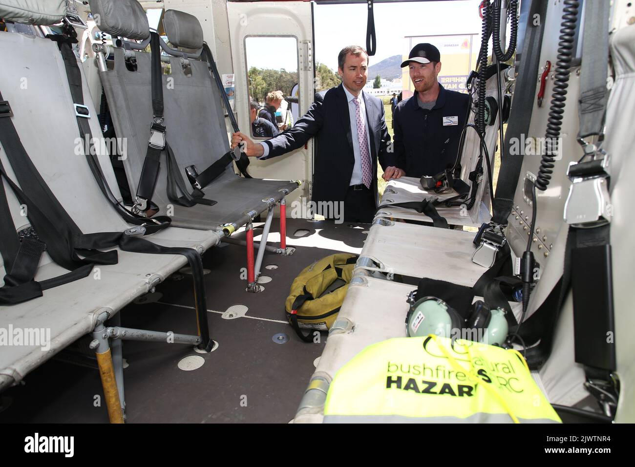 Minister Michael Keenan is shown around the Bell 412 firefighting ...