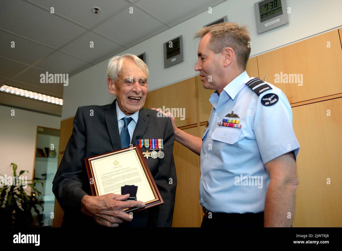 Former spitfire pilot Flight Lieutenant Kenneth Wright is presented ...
