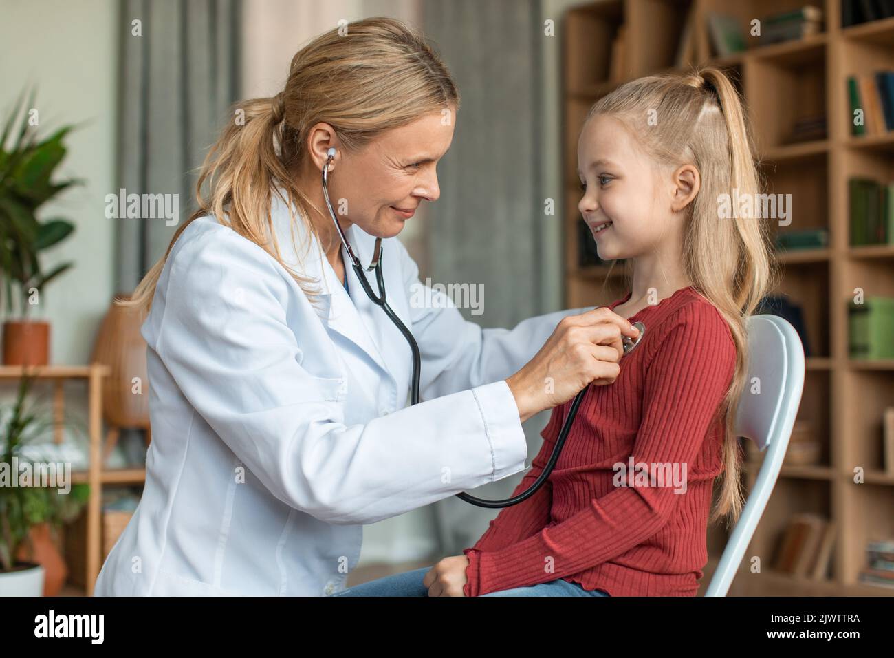 Happy little girl having checkup at pediatrician, child smiling while ...