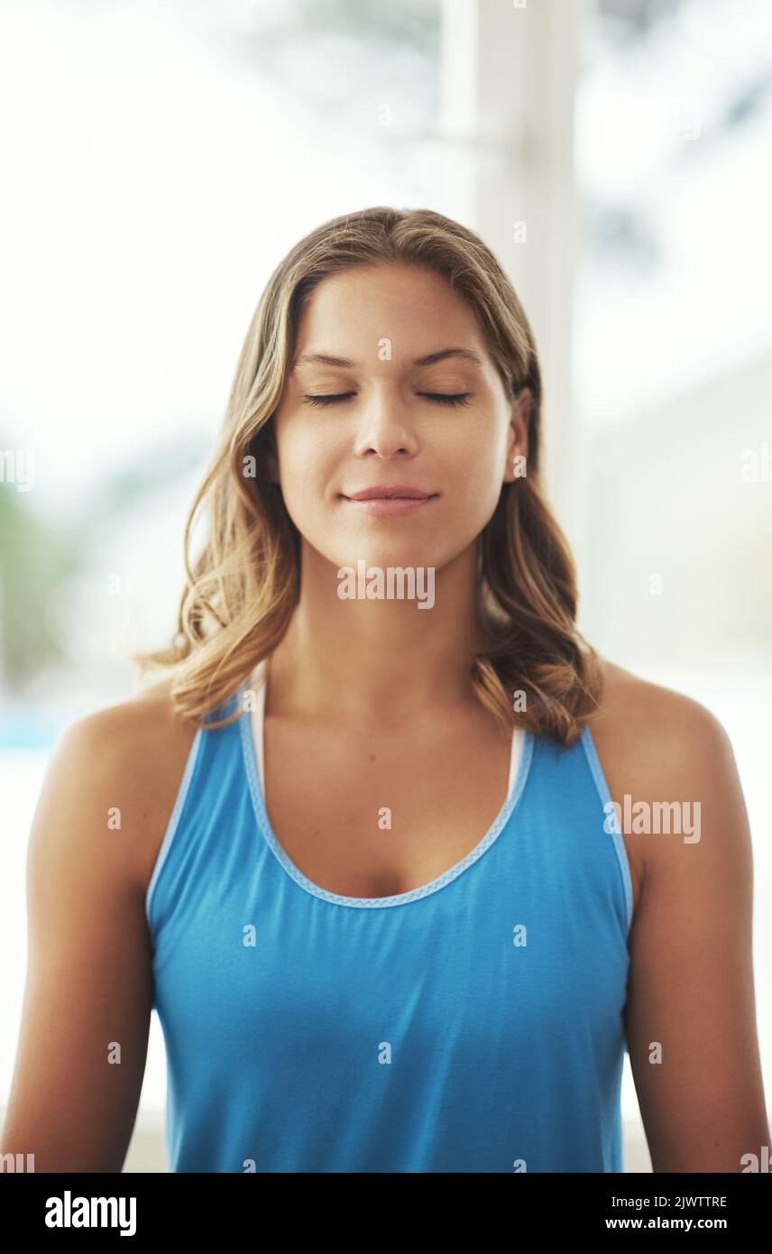 Clearing her mind. a young woman practicing the art of meditation at ...