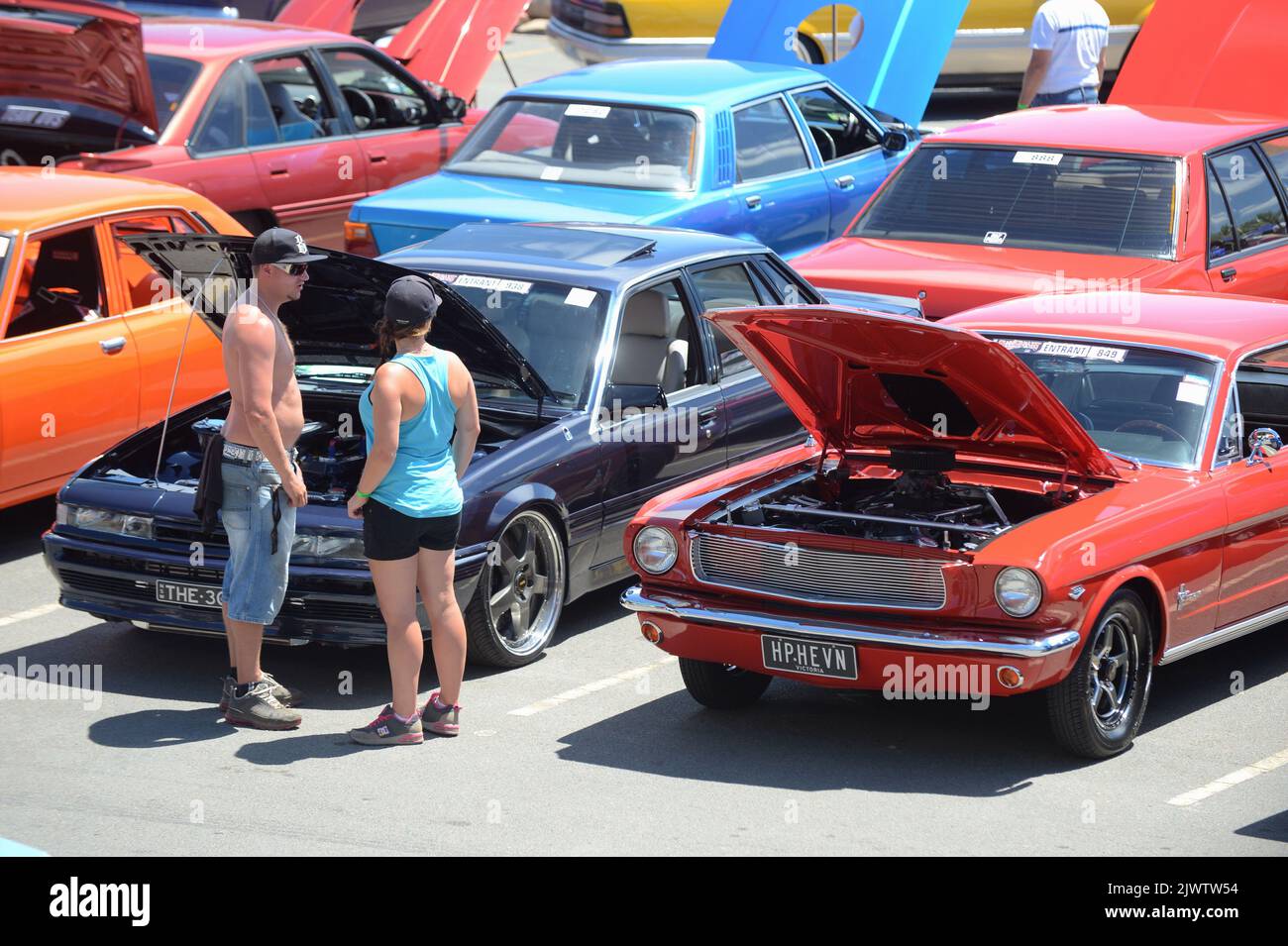 Spectators take a look at cars during the Summernats festival in ...