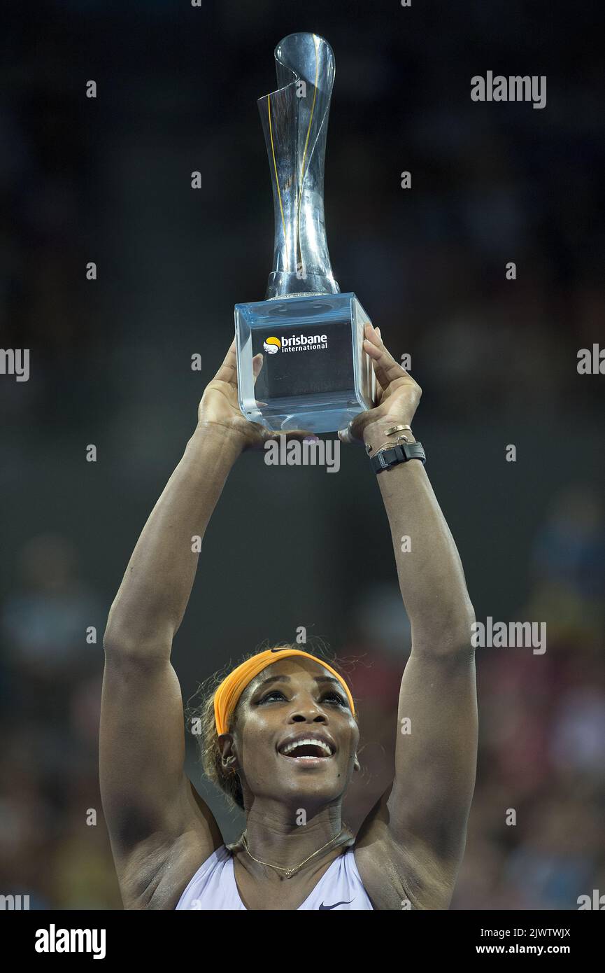 Serena Williams of USA poses holds the winners trophy aloft following her final match against ...