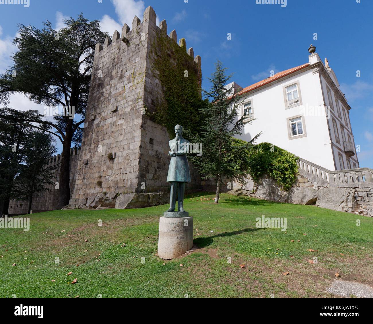 Statue in Porto in front of a house with a castle style turret ...