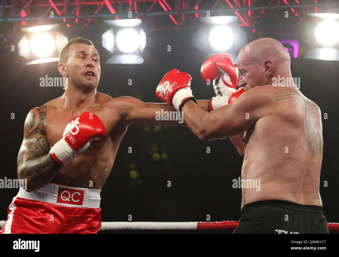 Quade Cooper, L, and Warren Tresidder during their cruiserweight bout ...