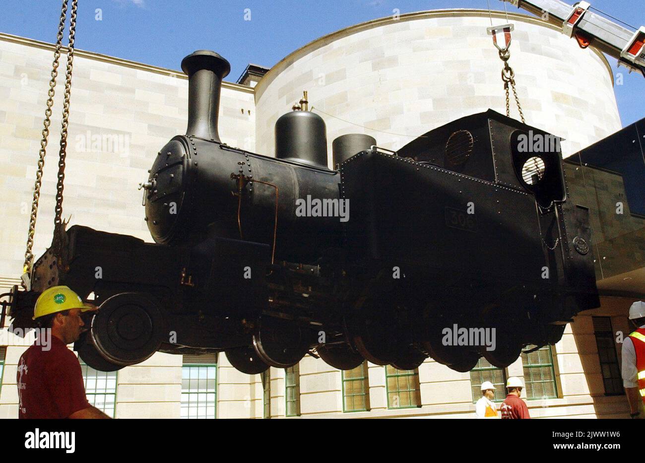 The Hunslet 306 steam engine hangs suspended between cranes before ...