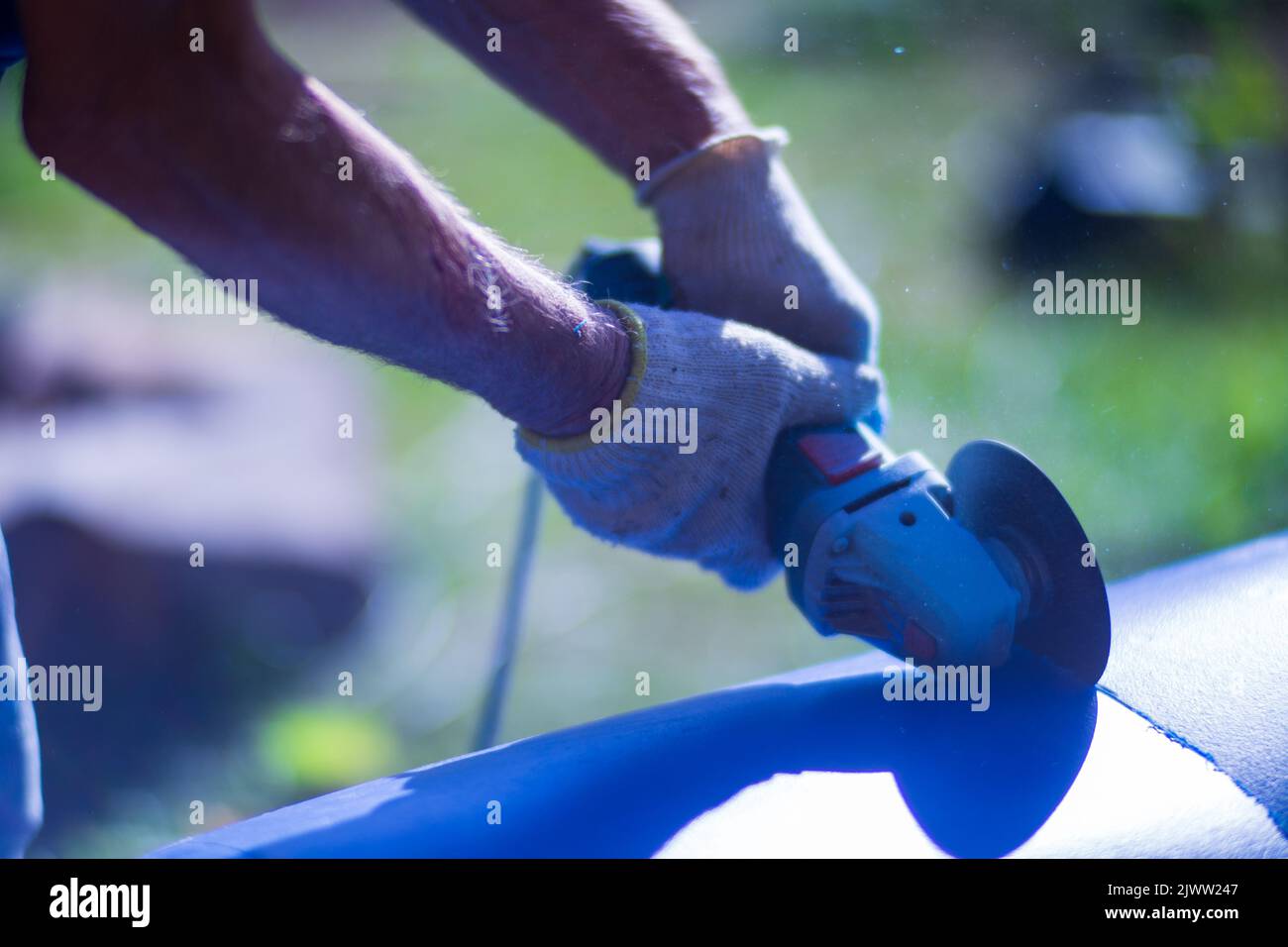 Man working with grinder saw, close up view on tool. Electric saw and ...