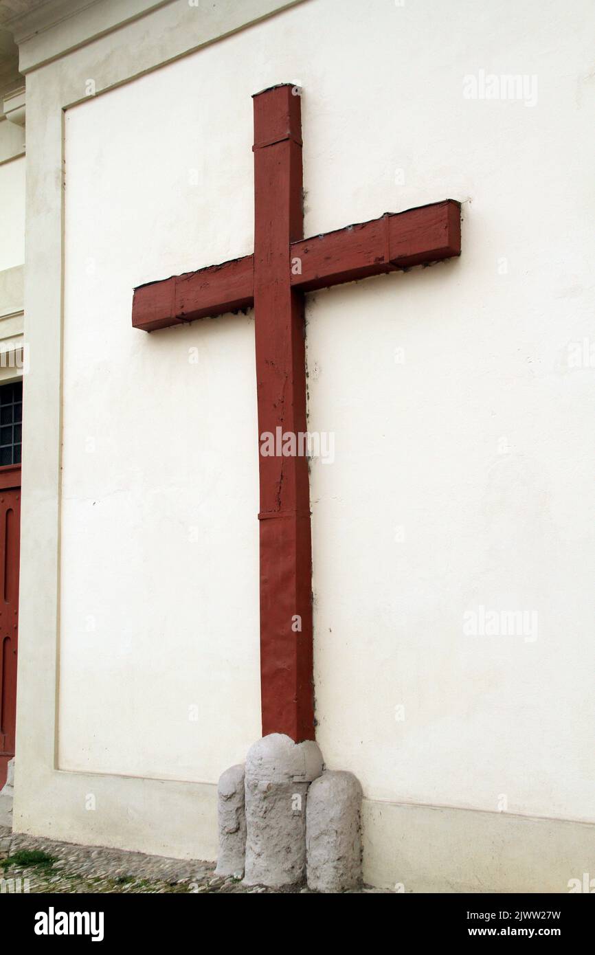 Large wooden cross on the facade of a church in Castel San Pietro Terme ...