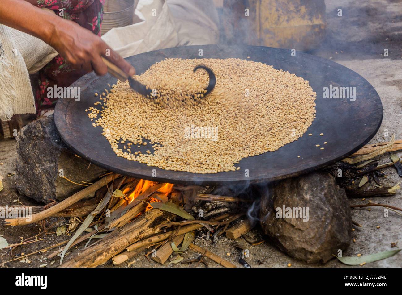 Teff grains being roasted for injera bread in Ethiopia Stock Photo - Alamy