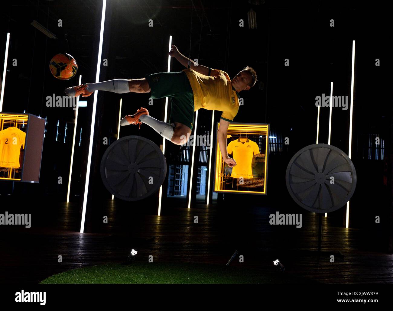 An acrobat performs at the launch of the Australian national team kit ...