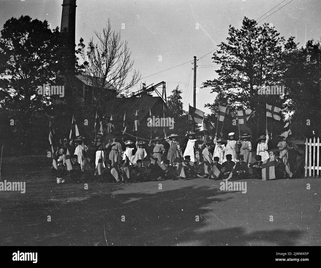 Children with flags at Gammelstilla mill, Torsåker, before 1915. Barn ...