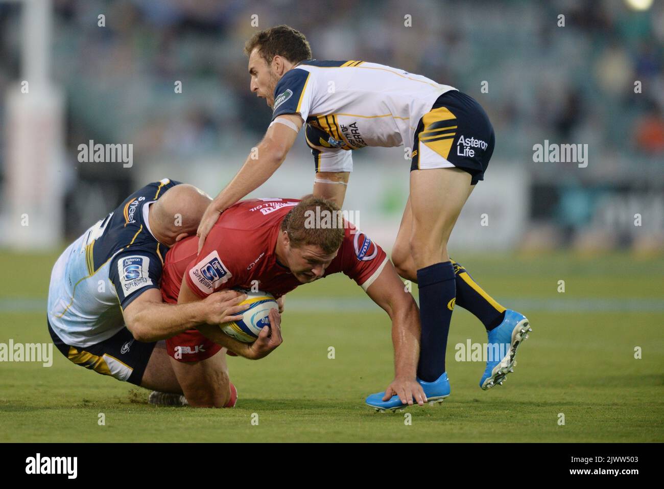 University of Canberra Brumbies' Nic White tackles Queensland Reds' Ben ...