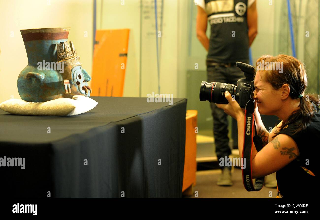 A photographer takes pictures of the 600 year old Aztec ceramic vessel ...