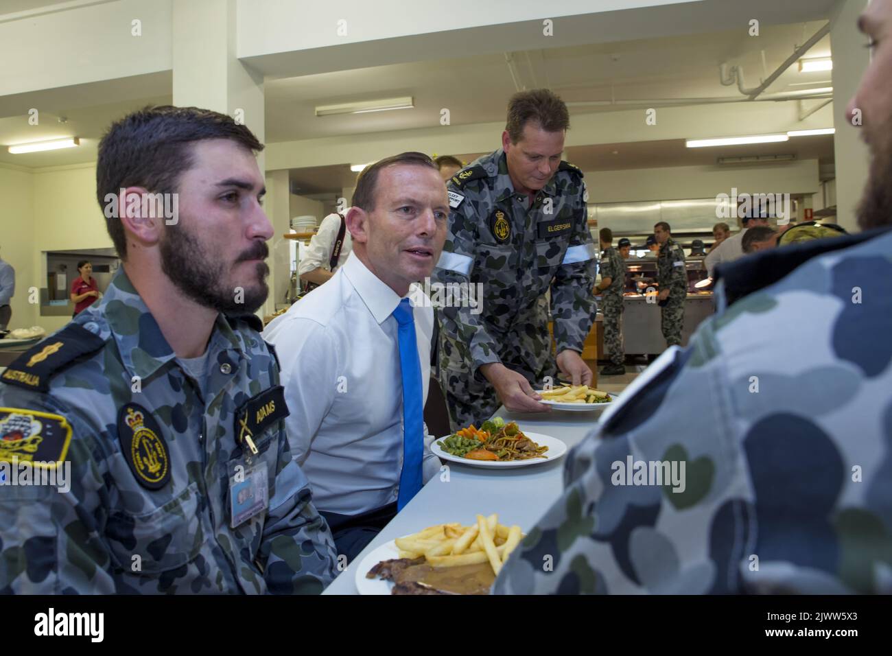 Prime Minister Tony Abbott shares a meal with troops during a visit to ...