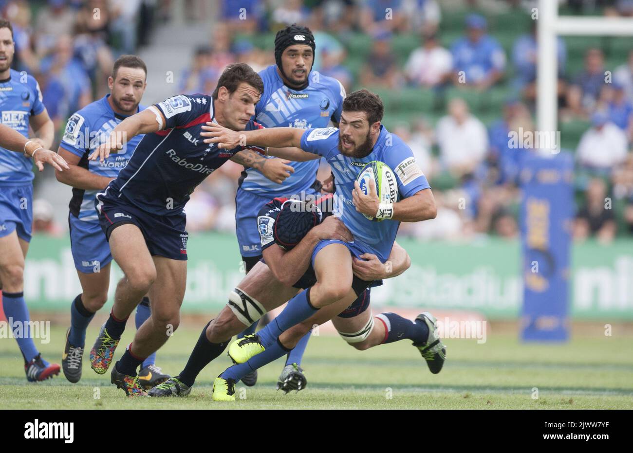 Jayden Hayward of the Western Force smashes through the Rebel's defence ...