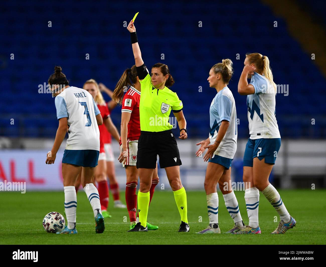 Referee Kateryna Monzul shows a yellow card to Slovenia's Sara Agrez ...