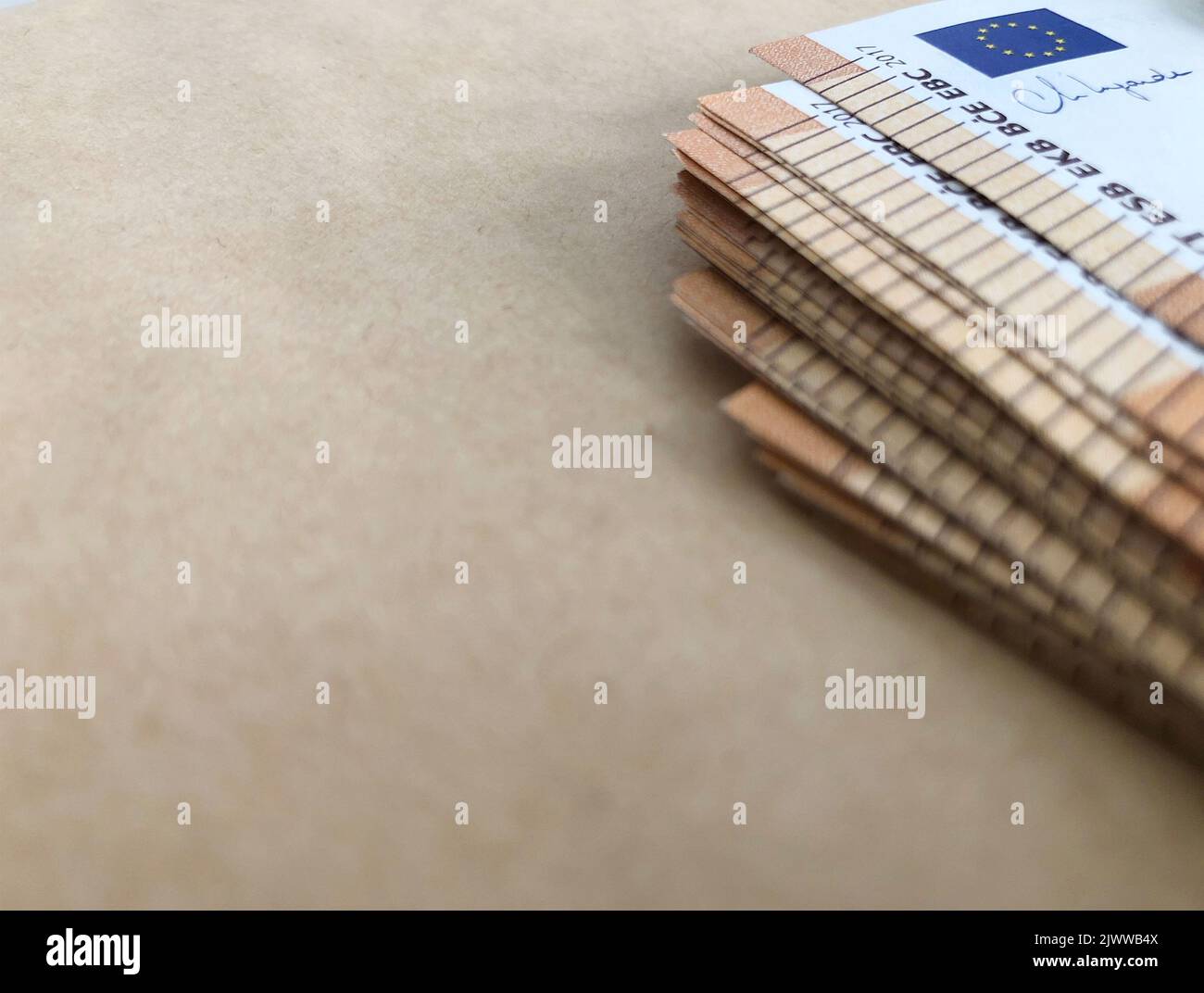 Close up of 50 euro banknotes on recycled brown paper. Pack of euro ...