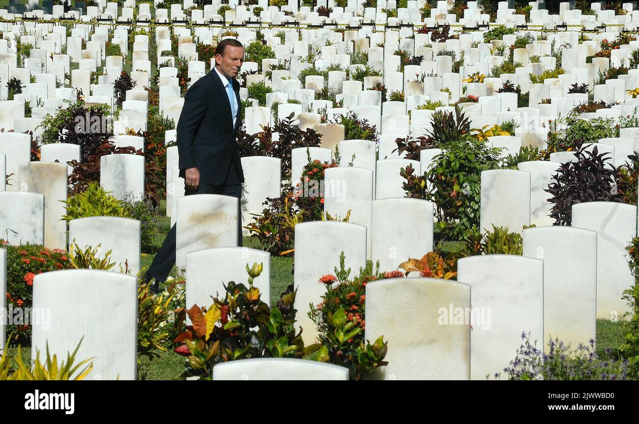 Prime Minister Tony Abbott Looks At Headstones During A Visit To Bomana prime-minister-tony-abbott-looks-at-headstones-during-a-visit-to-bomana