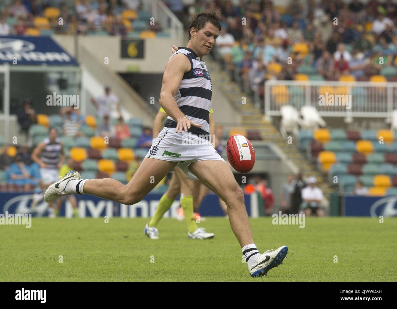 Cats player Andrew Mackie kicks ahead during his 200th game in the ...