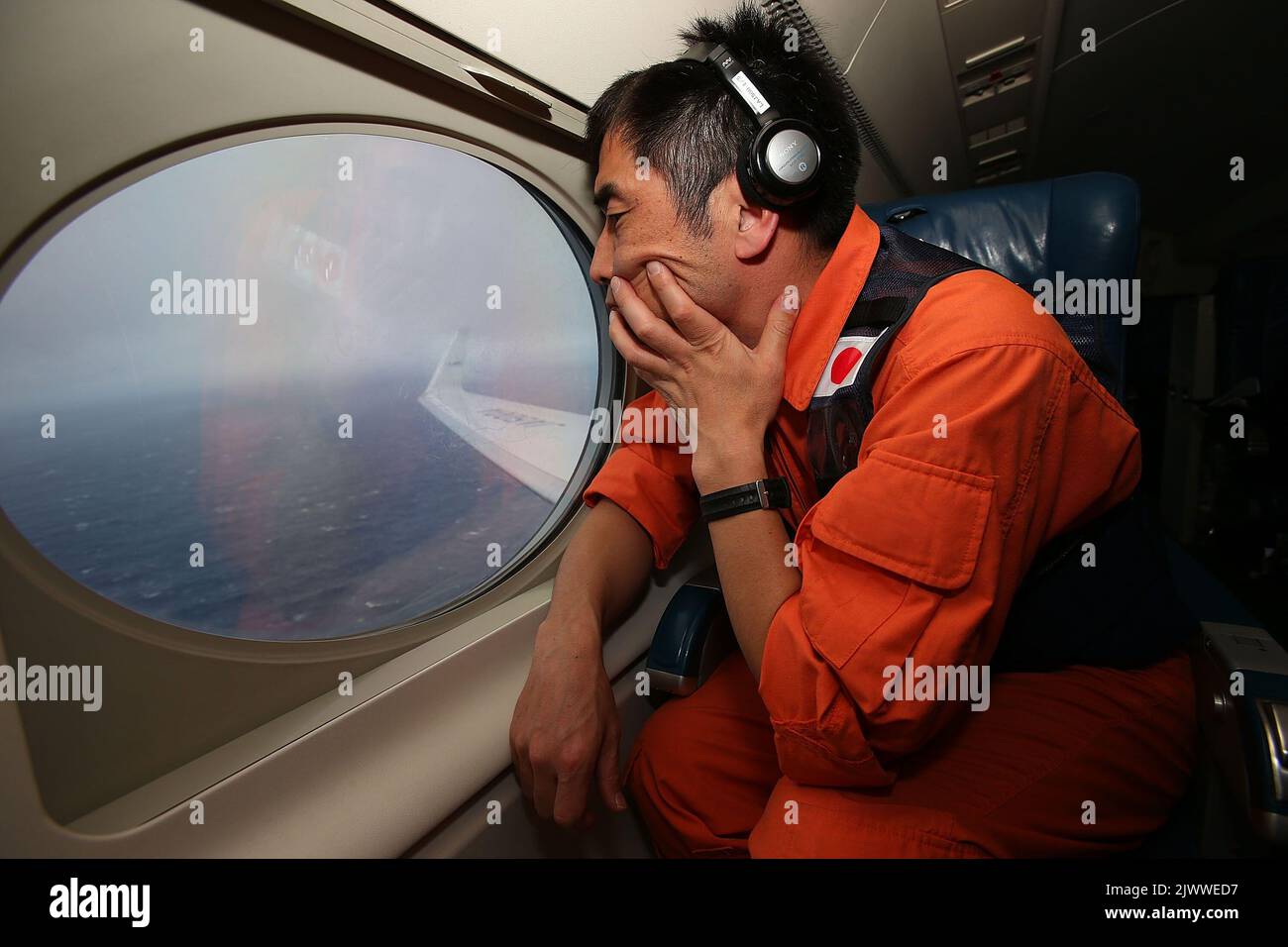 Koji Kubota of the Japan Coast Guard keeps watch for debris on board ...