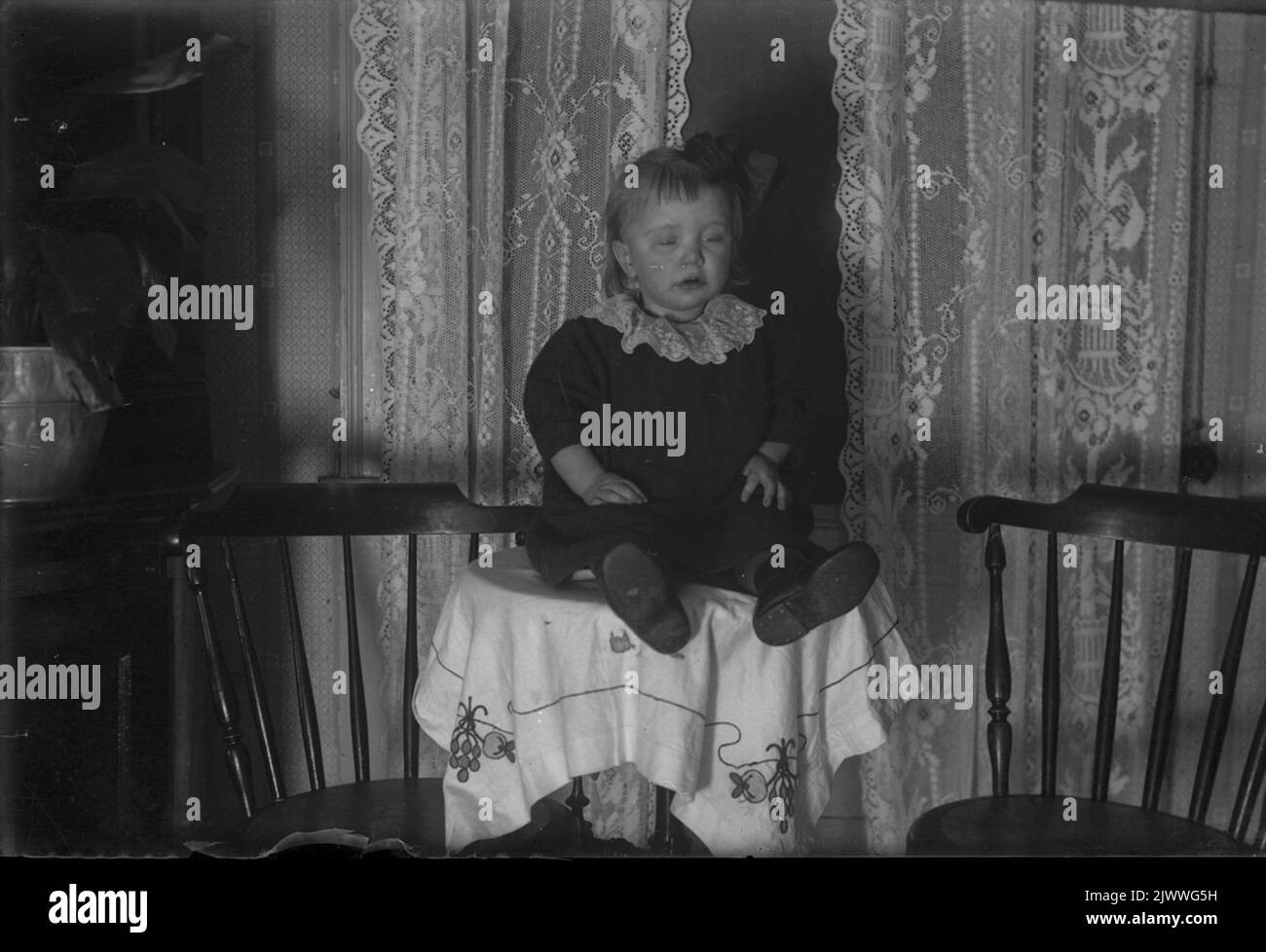Child seated Black and White Stock Photos & Images - Alamy