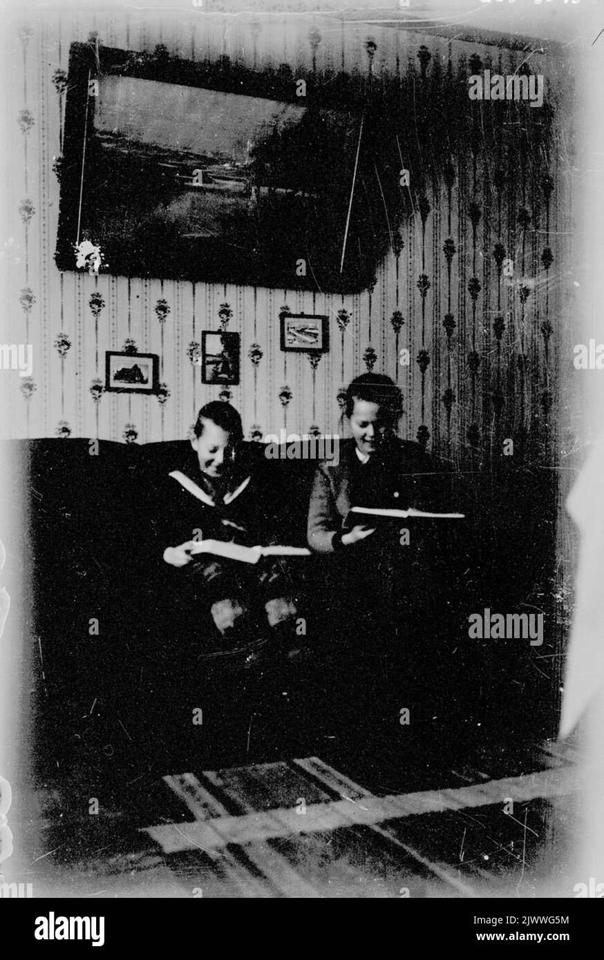 Two children reading. Blurry picture. Två barn som läser. Suddig bild ...