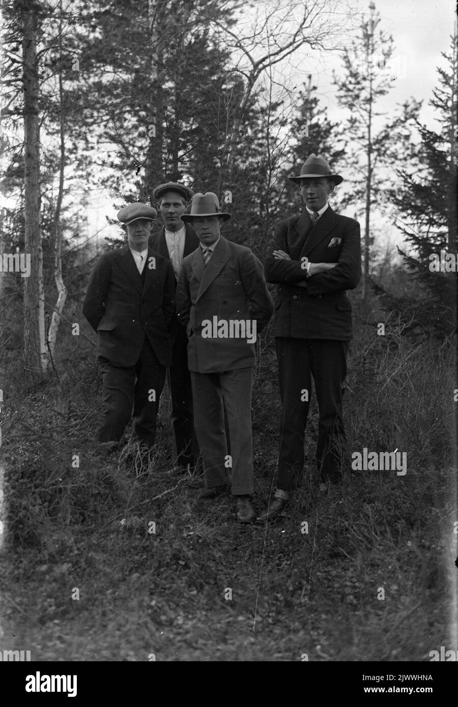 Four men standing in Black and White Stock Photos & Images - Alamy