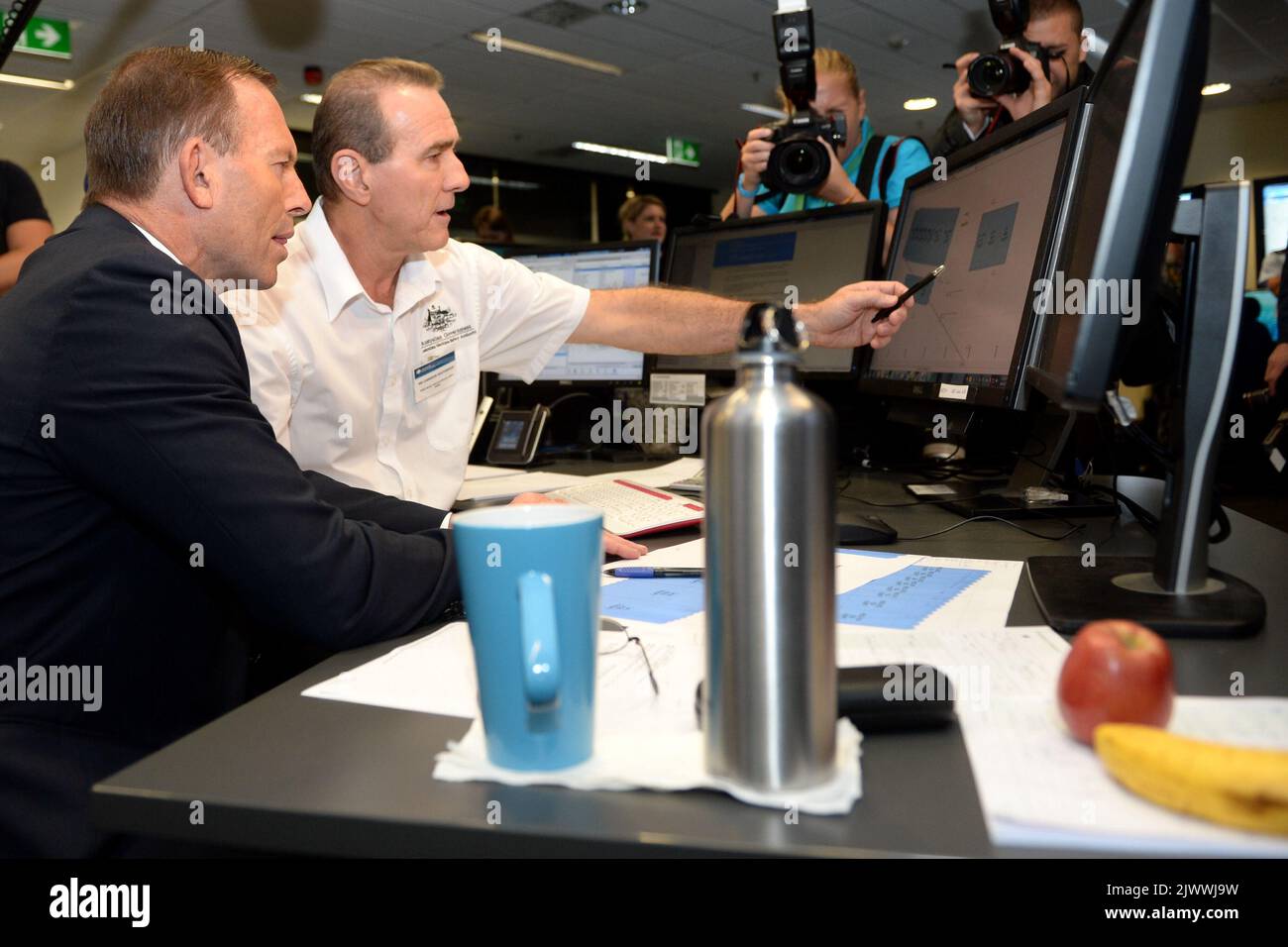 Prime Minister Tony Abbott listens to AMSA search and rescue officer ...