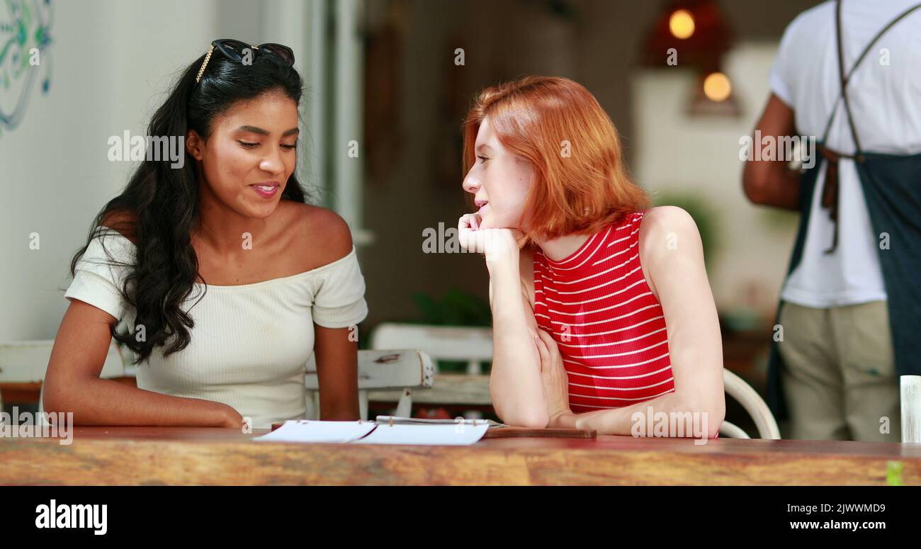 Two casual girl-friends interaction, laughing and smiling together ...