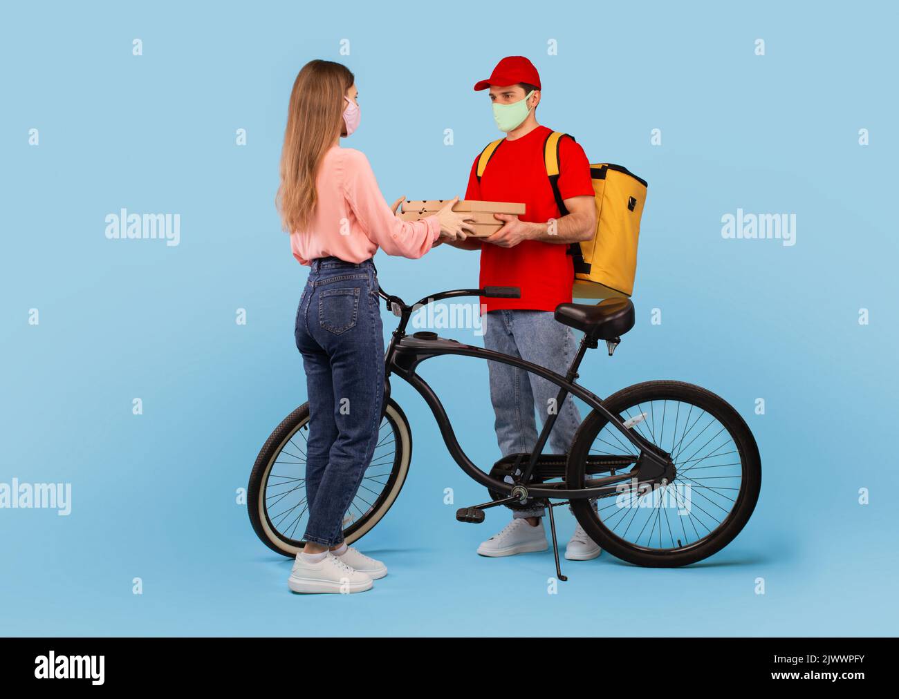 Young male pizza courier hi-res stock photography and images - Alamy