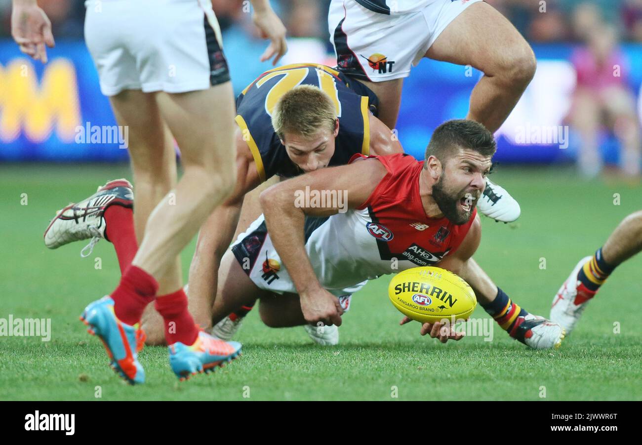 Mark Jamar of the Melbourne Demons looks to hand ball during the round ...