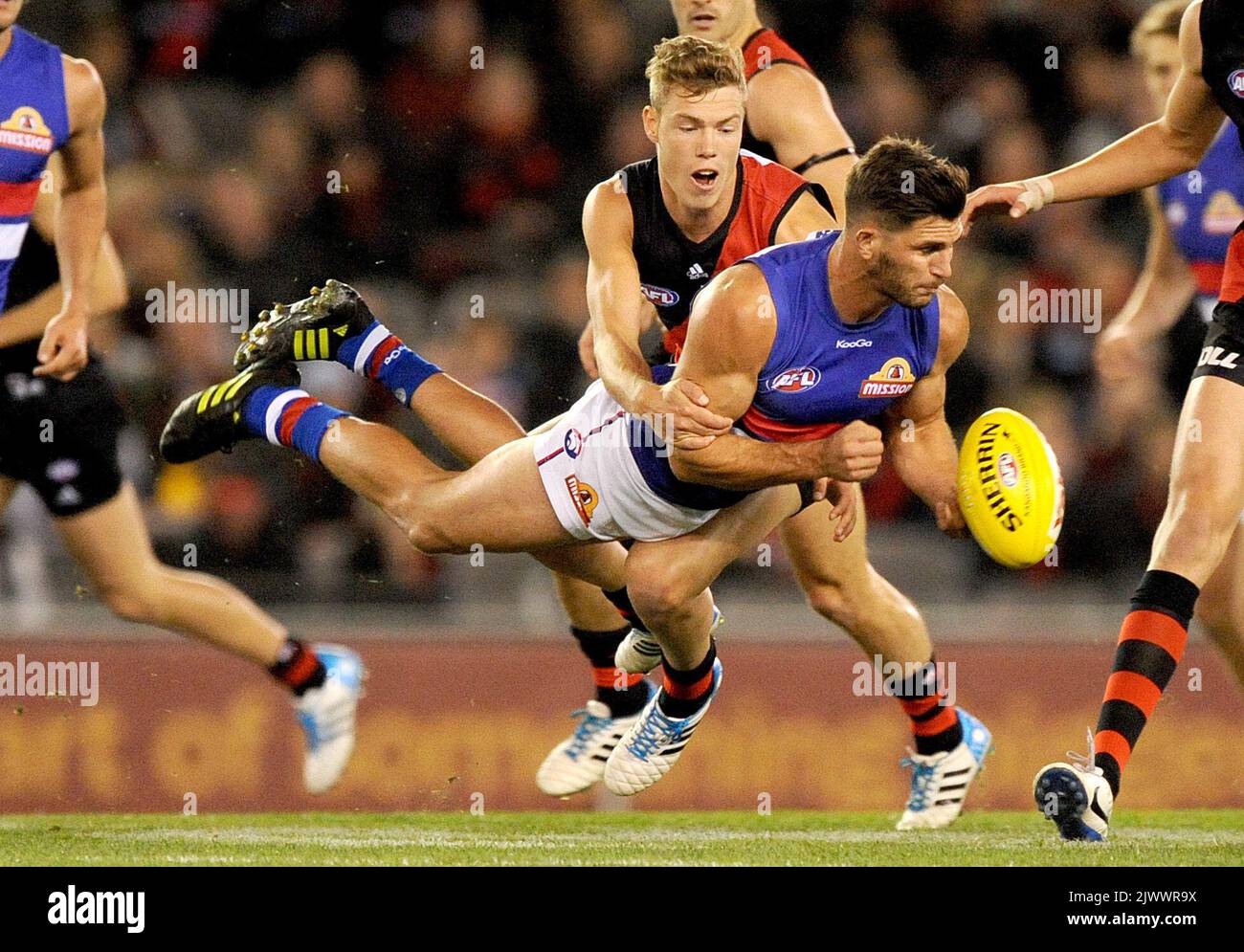 Koby Stevens of the Western Bulldogs is tackled by Jake Melksham of ...