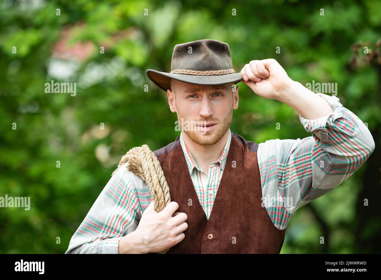 Cowboy farmer man in country side wearing western cowboy hat. Cowboy ...
