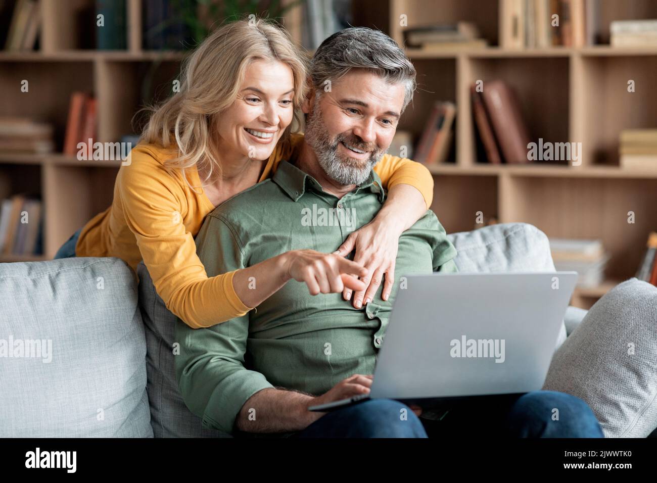 Happy Middle Aged Couple With Laptop Ordering Things From Internet ...