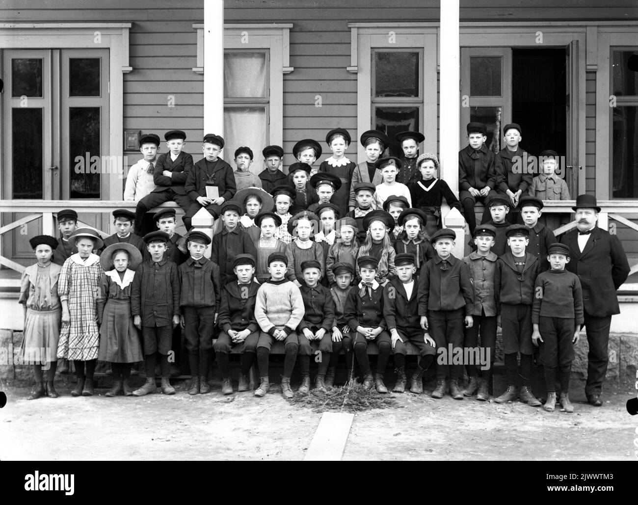 Teacher with a collection of school students, primary school in ...