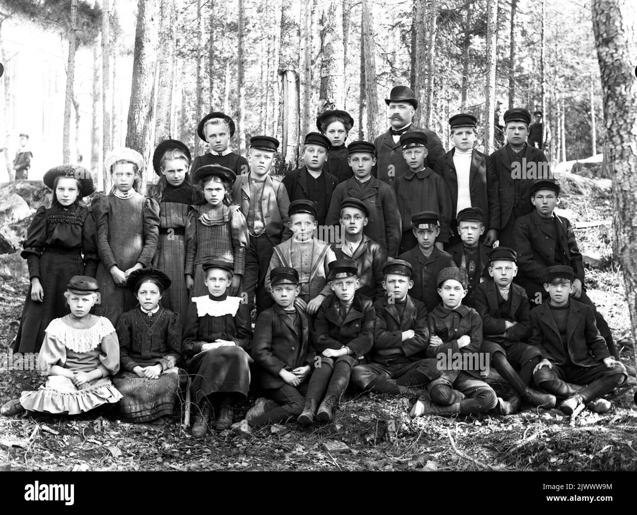 Teacher with school class out in the woods. Lärare med skolklass ute i ...