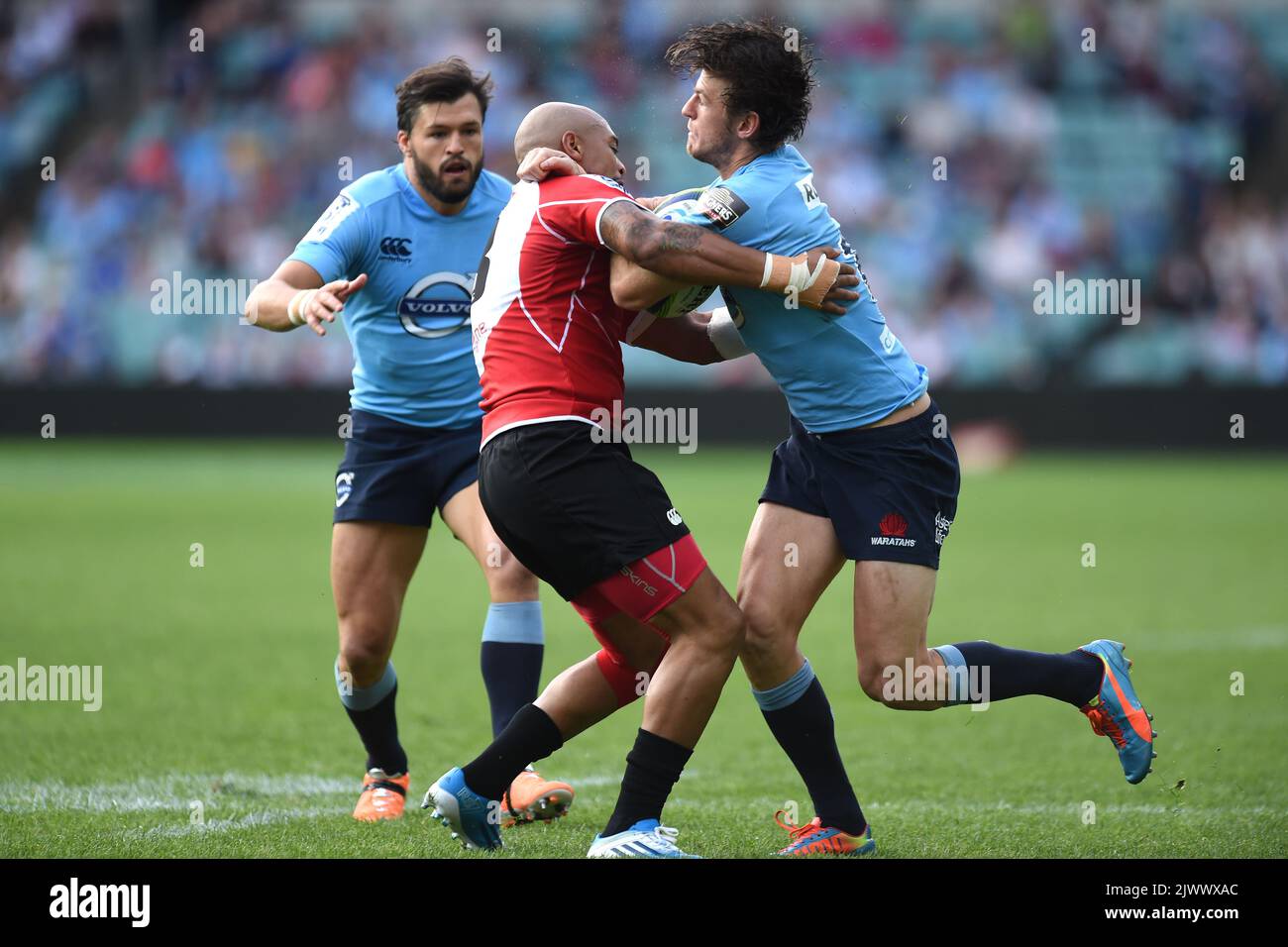 The Waratahs' Rob Horne is tackled by Lionel Mapoe of the Lions during ...
