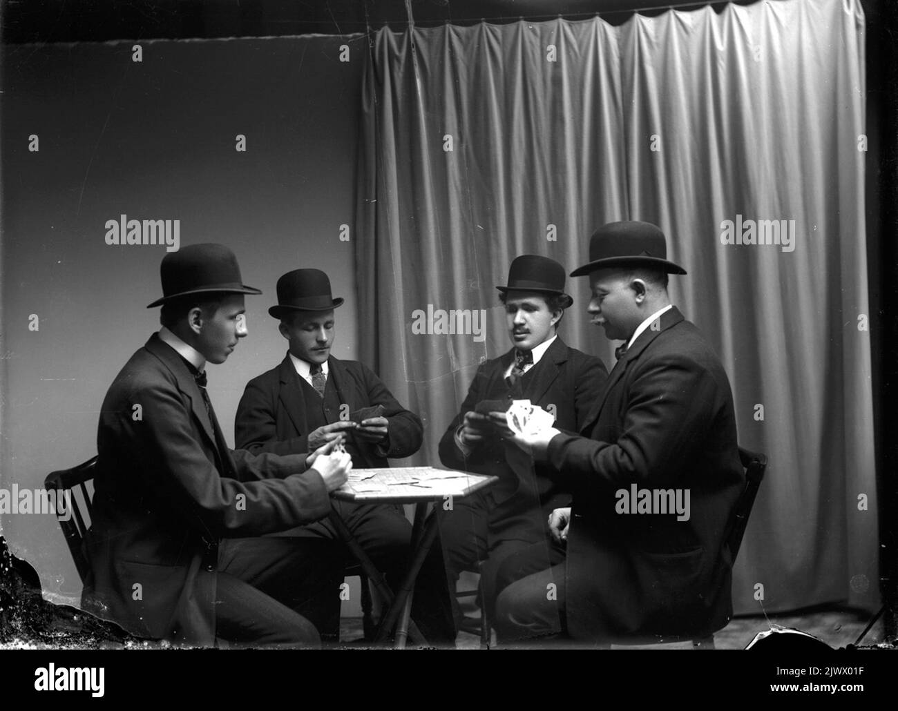 Four men sitting Black and White Stock Photos & Images - Alamy