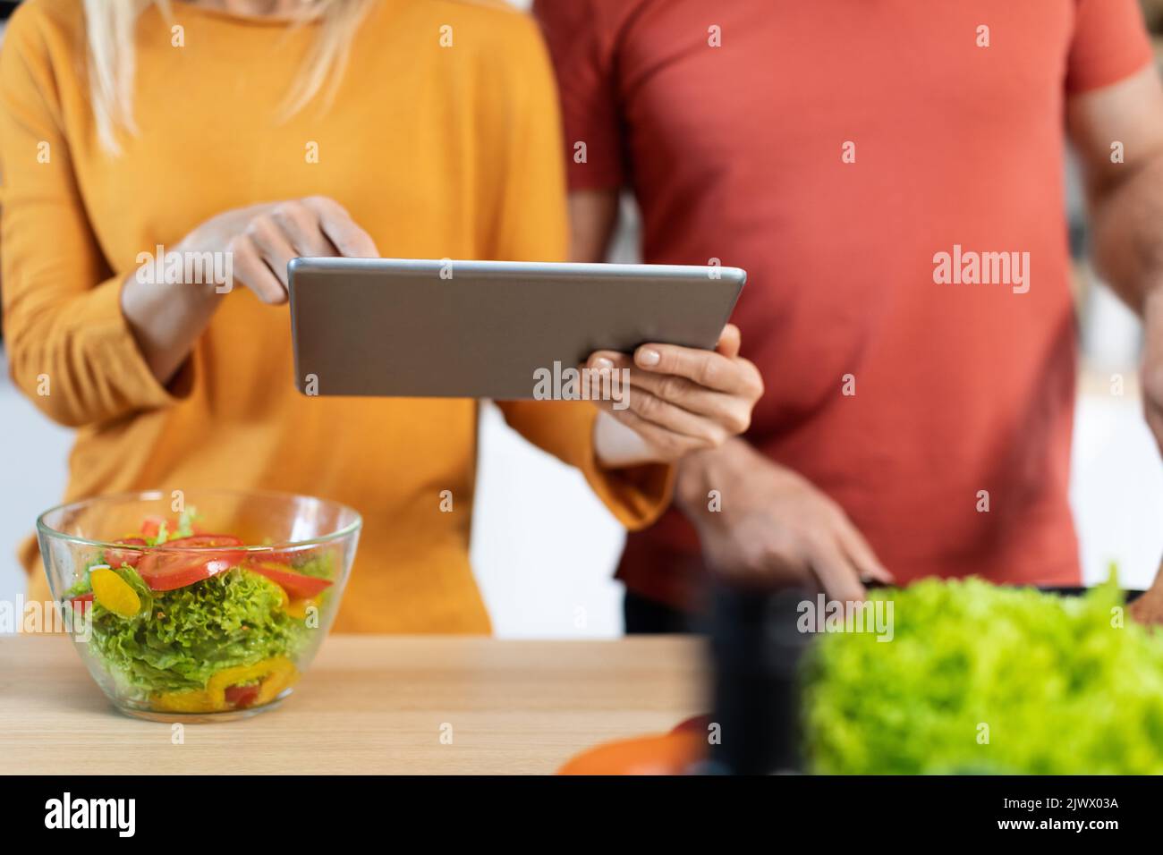 Blonde woman cooking husband hi-res stock photography and images - Alamy