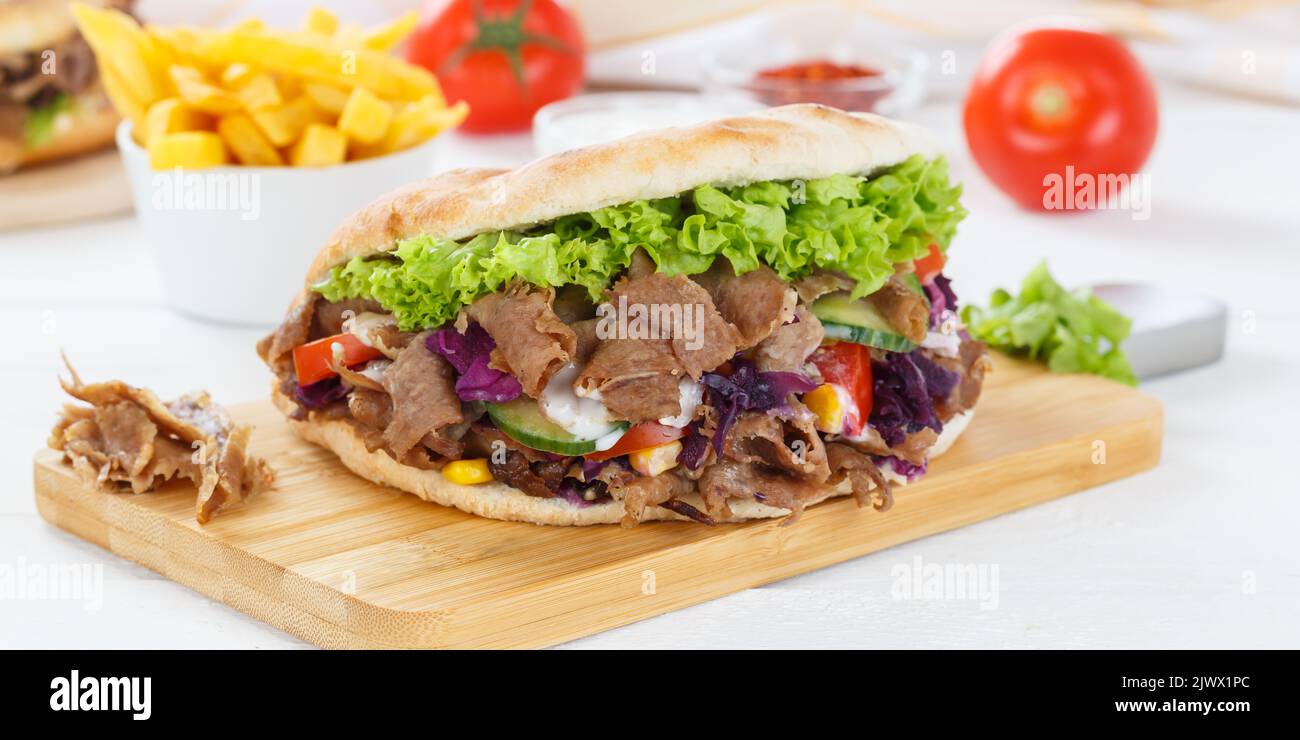 Döner Kebab Doner Kebap fast food meal in flatbread with french fries ...