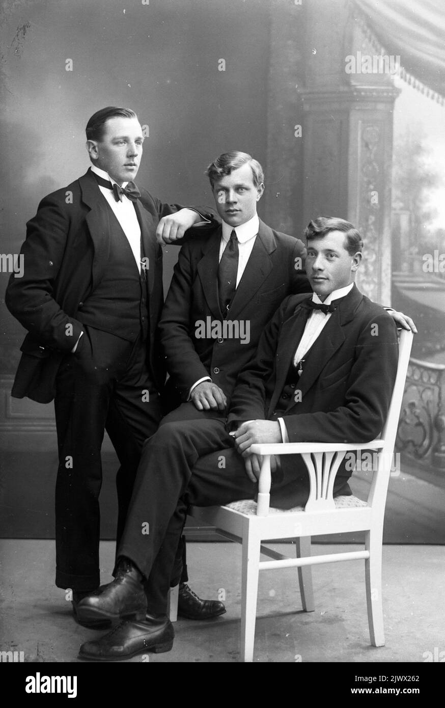 Portrait man standing three Black and White Stock Photos & Images - Alamy