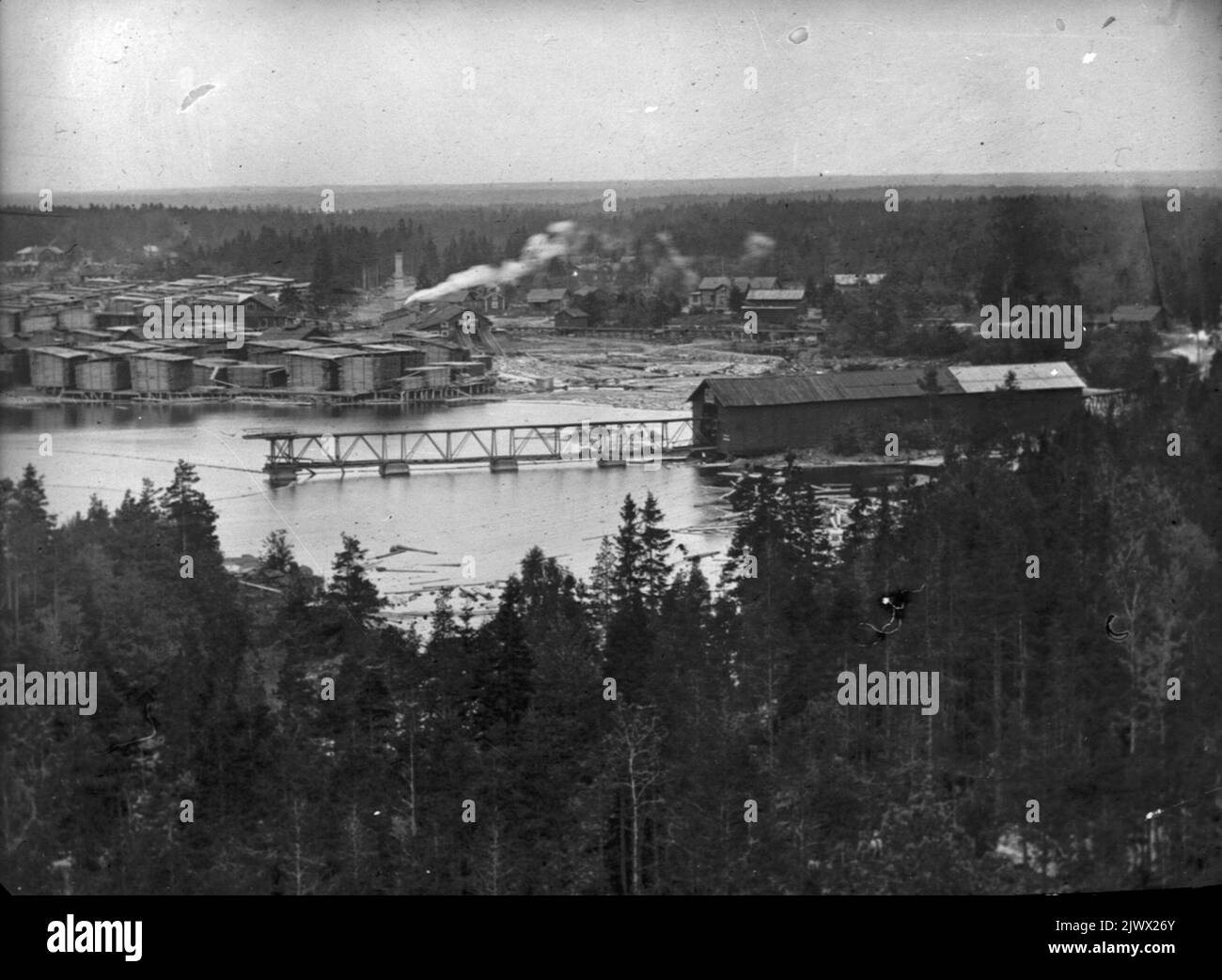 Lake, timber storage, industrial plant. Sjö, timmerupplag ...