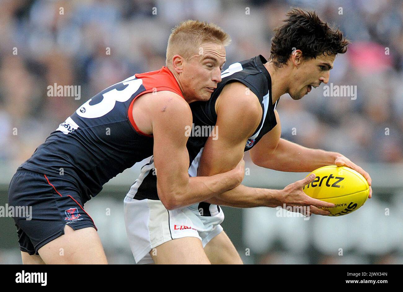 Scott Pendlebury of Collingwood is tackled by Bernie Vince of Melbourne ...
