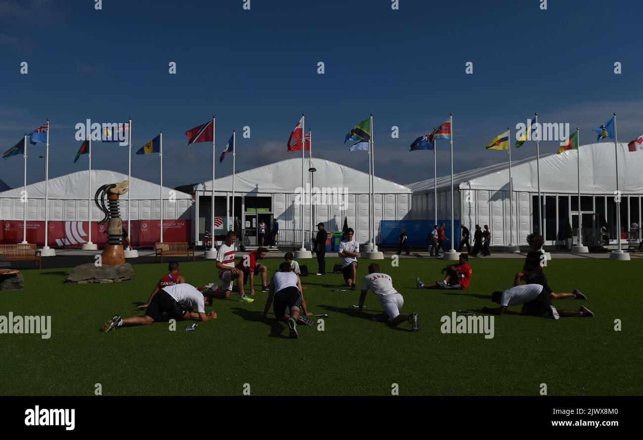Canadian athletes stretch in front of a statue of the Loch Ness Monster ...