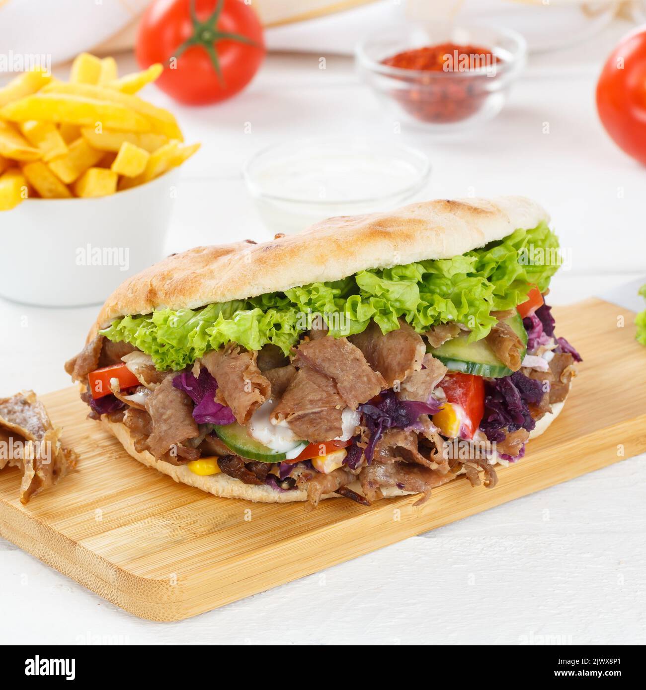 Döner Kebab Doner Kebap fast food meal in flatbread with french fries ...