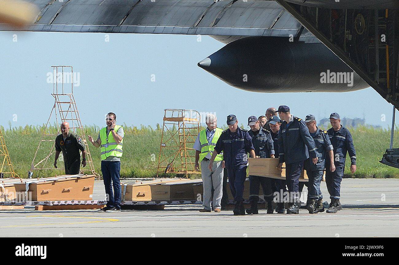 Bodies are transported onto a dutch C130 aircraft prior to a ramp ...