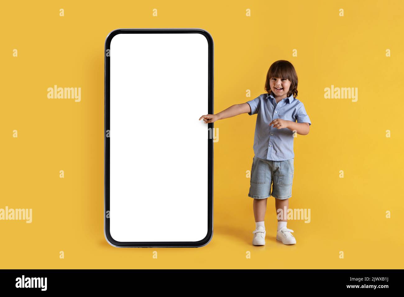 Educational kids mobile app. Happy positive little boy pointing aside ...