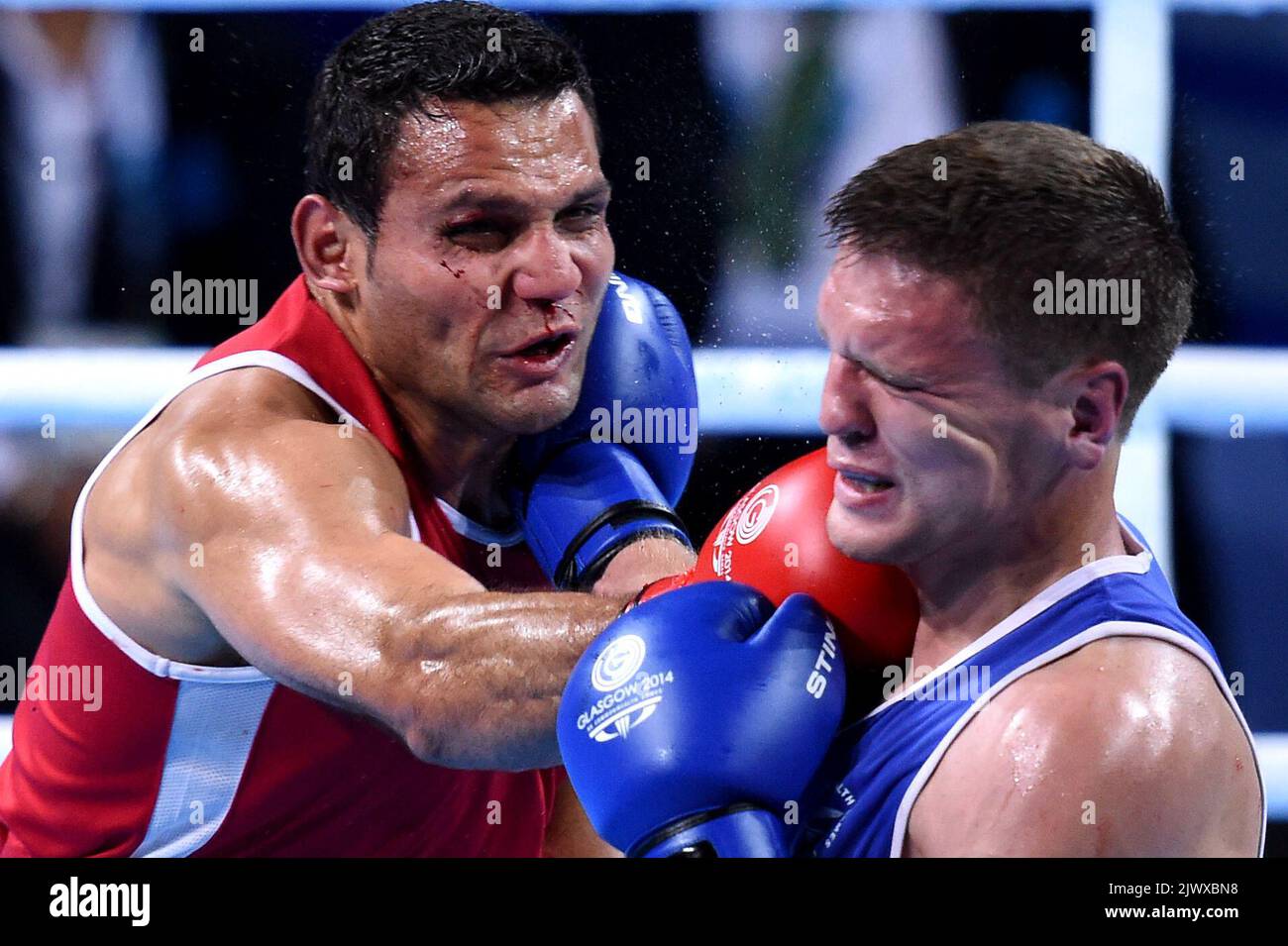 Canada's Samir El-mais punches New Zealand's David Light (blue) during ...
