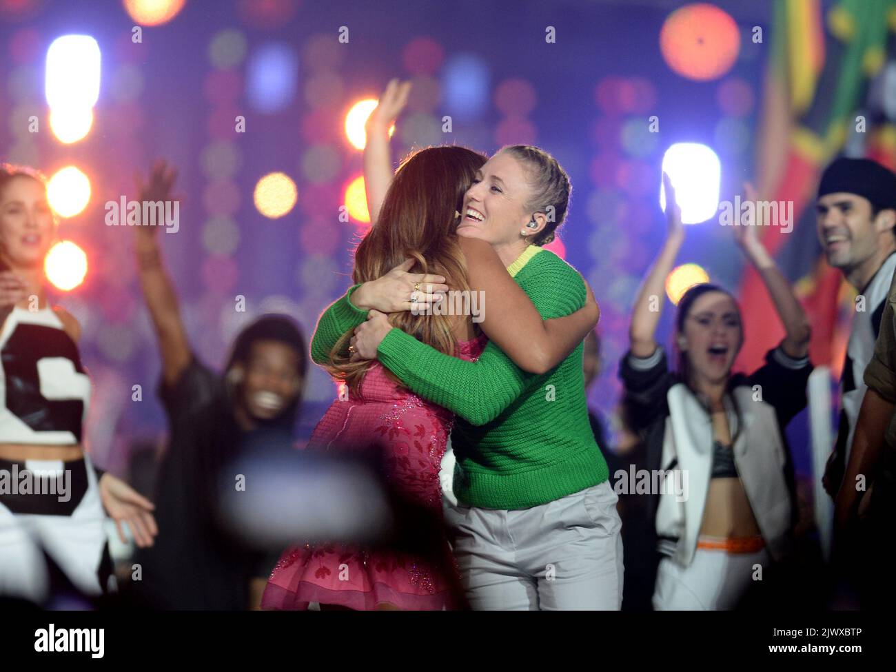 Australian singer Jessica Mauboy hugs athlete Sally Pearson on stage ...