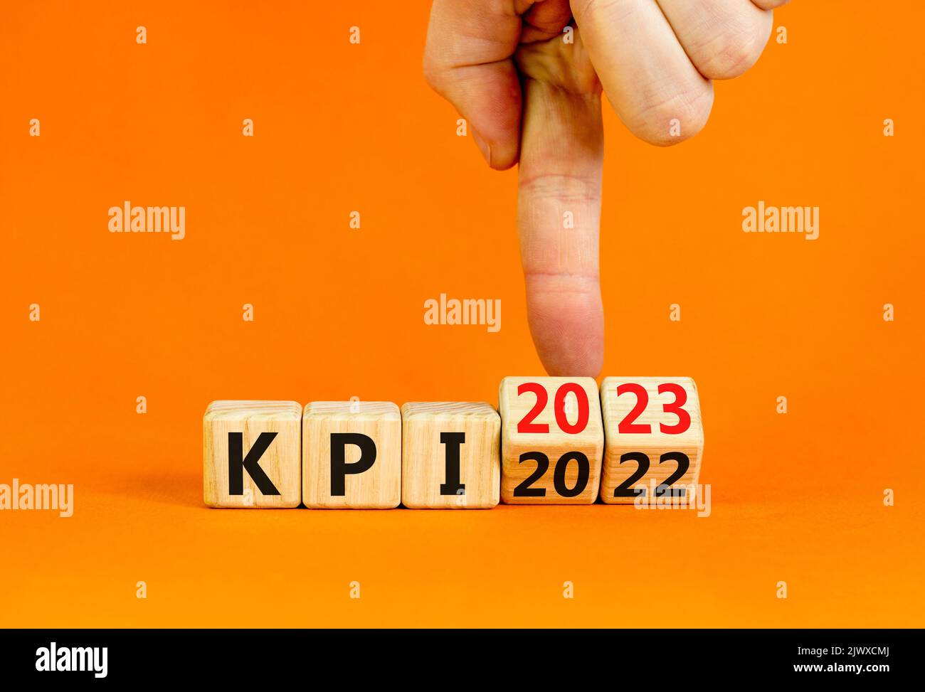 KPI, key performance indicator symbol. Businessman turns wooden cubes ...